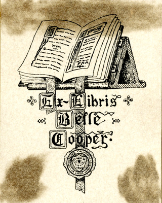 "Bookplate of an open book on a book stand."